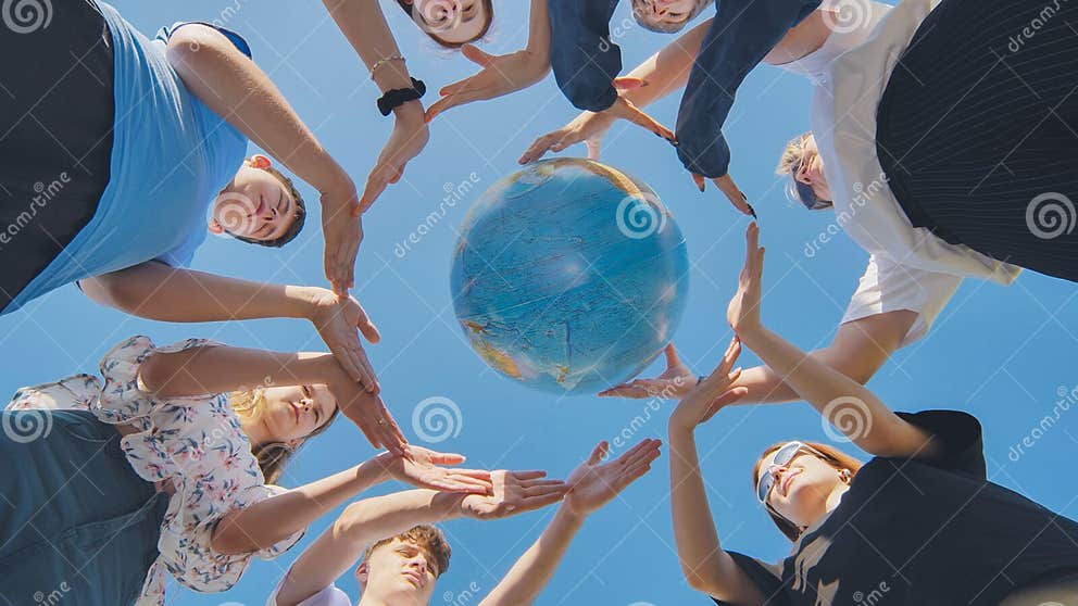 Students Make a Circle Around the Globe of the World. the Concept of ...