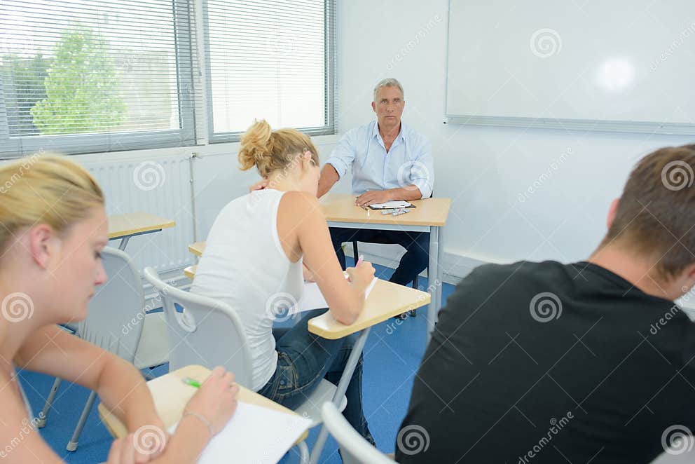 Students Passing Exam in Class Stock Image - Image of education ...