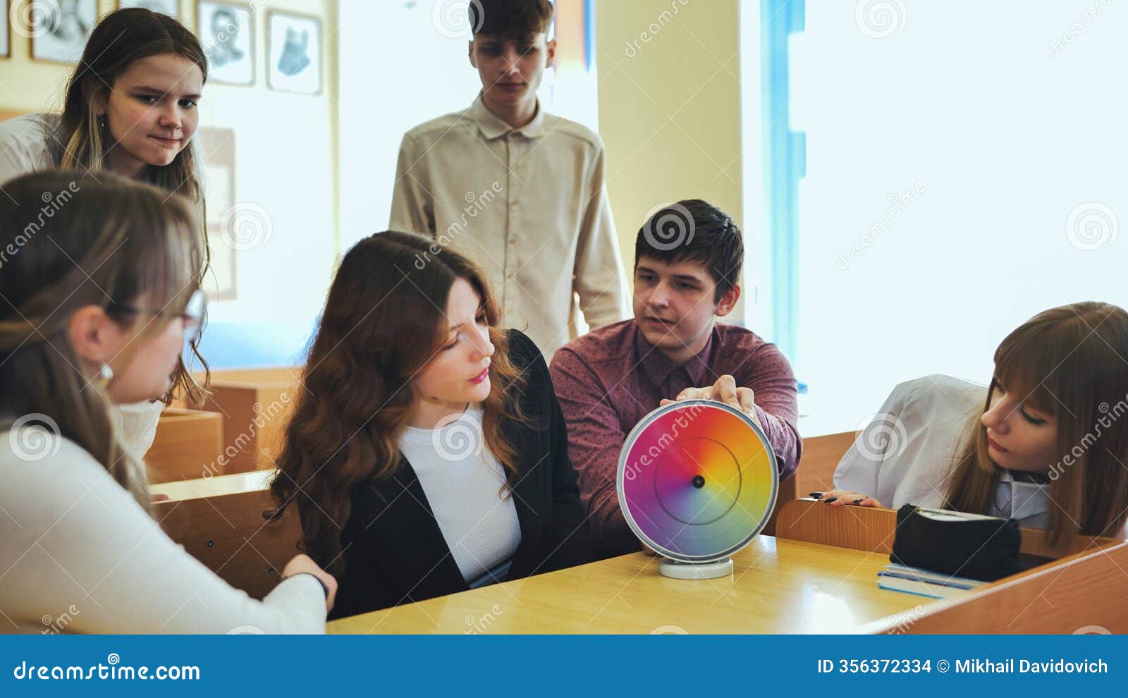Students in Physics Class Spin Newton S Multicolored Disk. Stock Photo ...