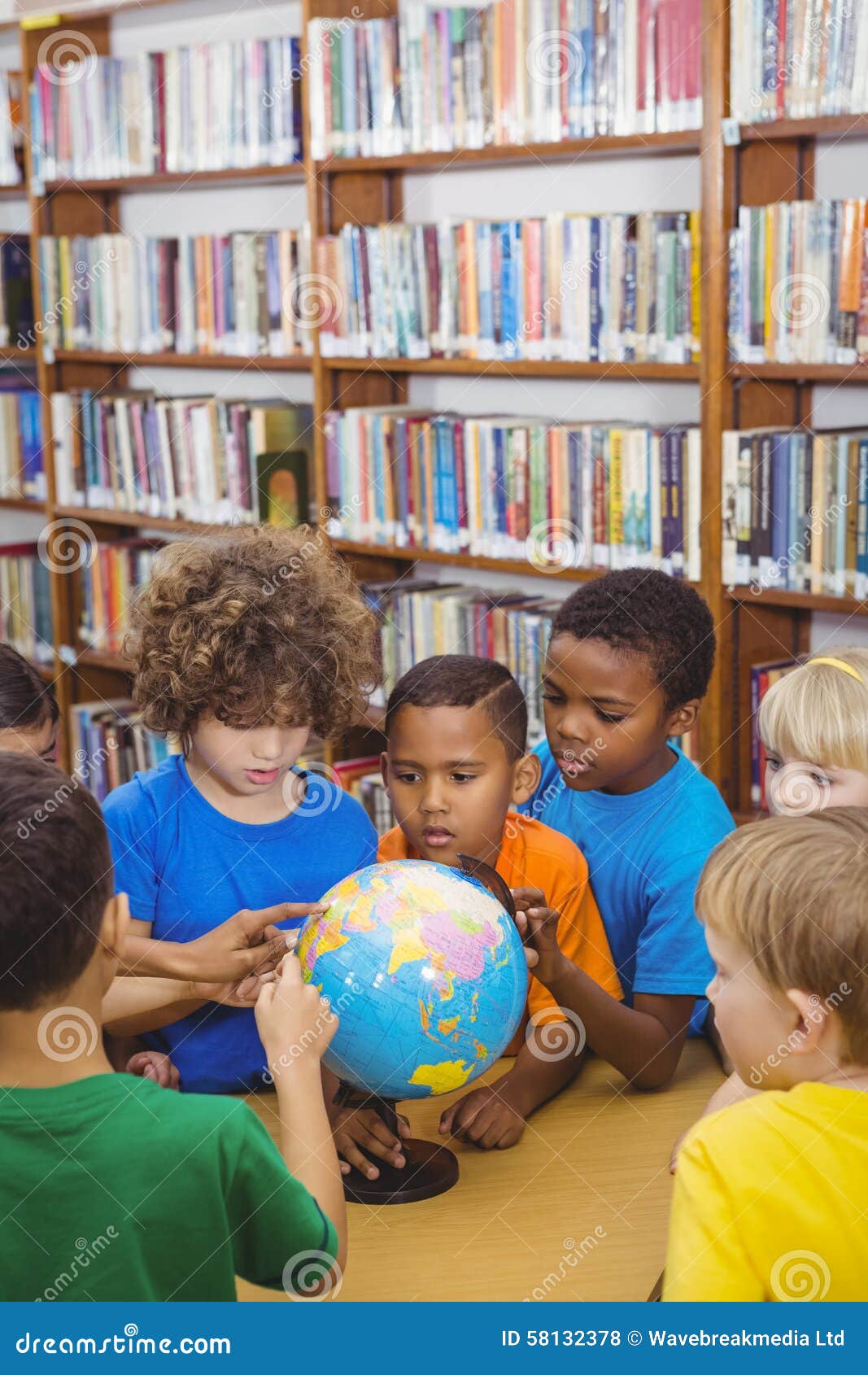 Students Pointing at a Globe Stock Photo - Image of medium, indoors ...