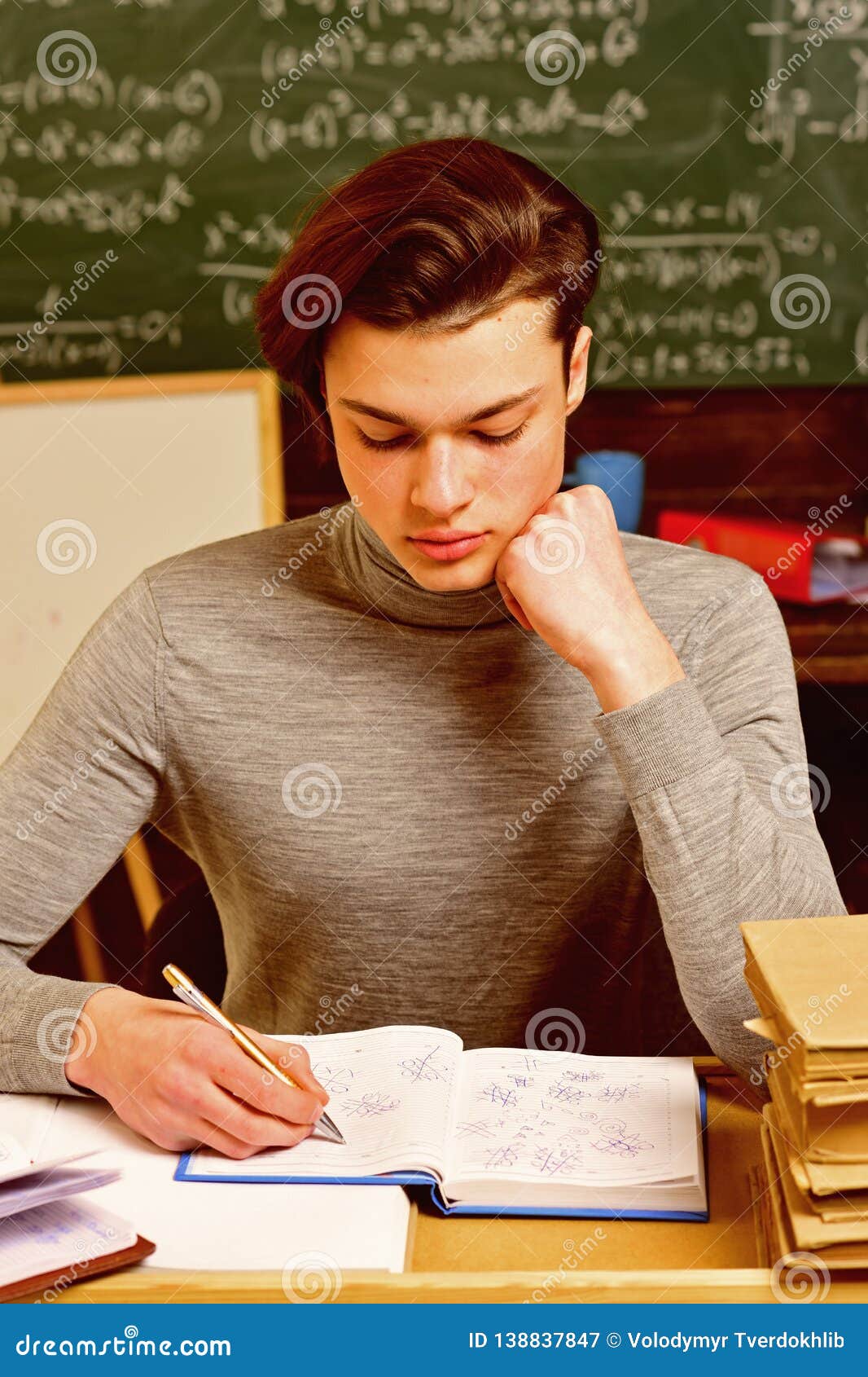 Students Preparing for Exams in Classroom Interior Behind Table. Making ...