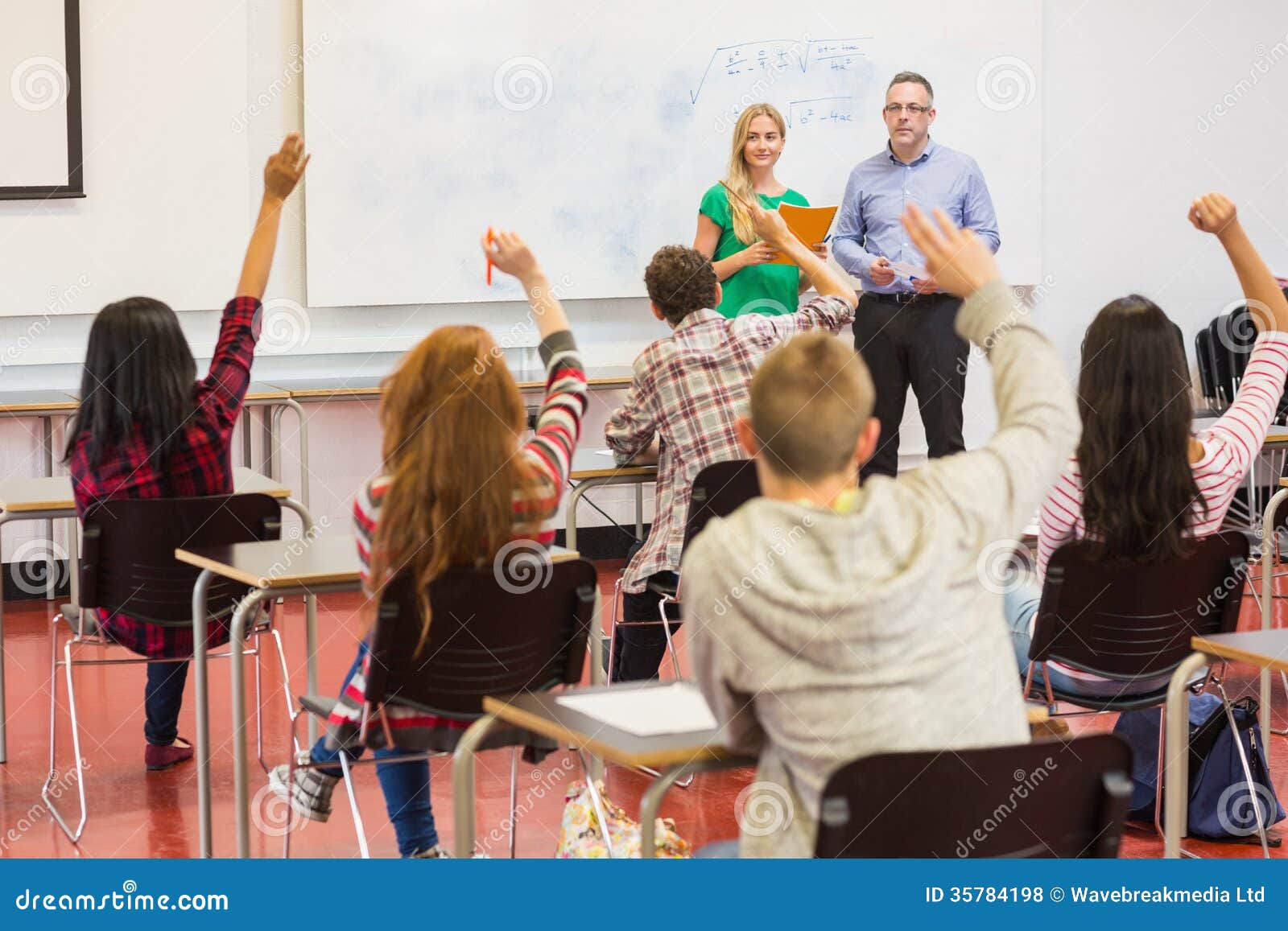 Students Raising Hands in the Classroom Stock Photo - Image of young ...