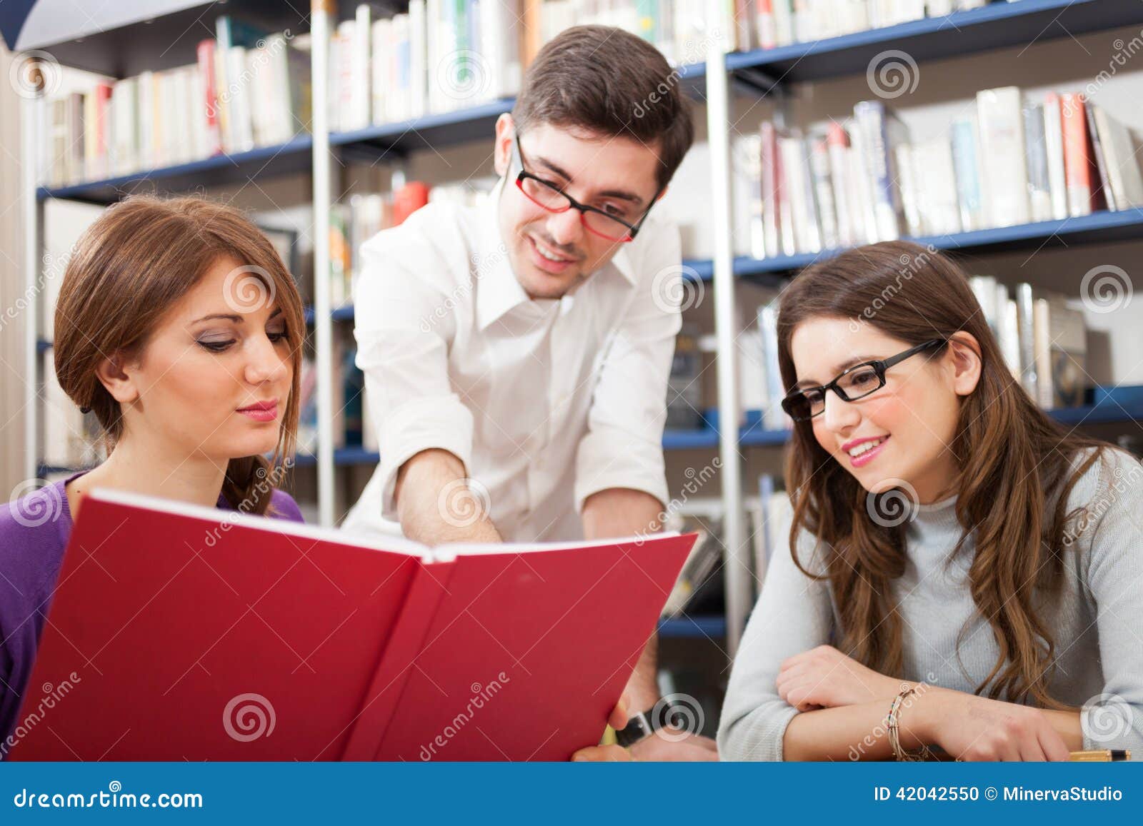 Students Reading a Book in a Library Stock Photo - Image of male ...