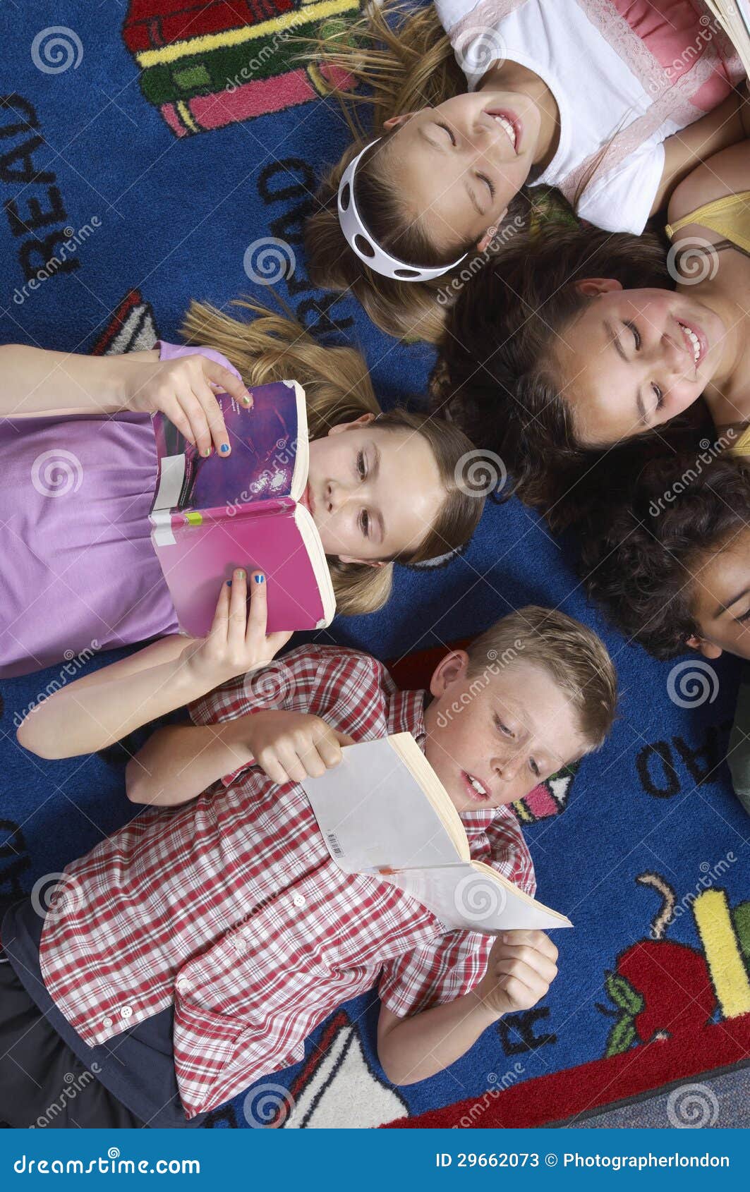 Students Reading Books while Lying on Carpet Stock Image - Image of ...