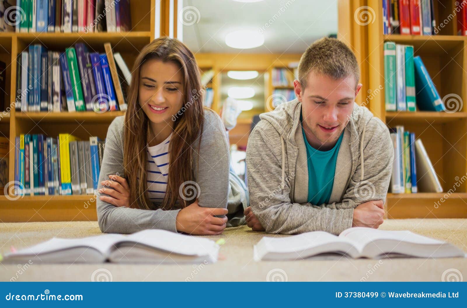 Students Reading Books while Lying on the Library Floor Stock Image ...