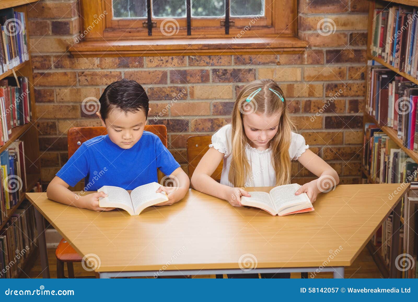 Students Reading Books while Sitting Down Stock Image - Image of female ...