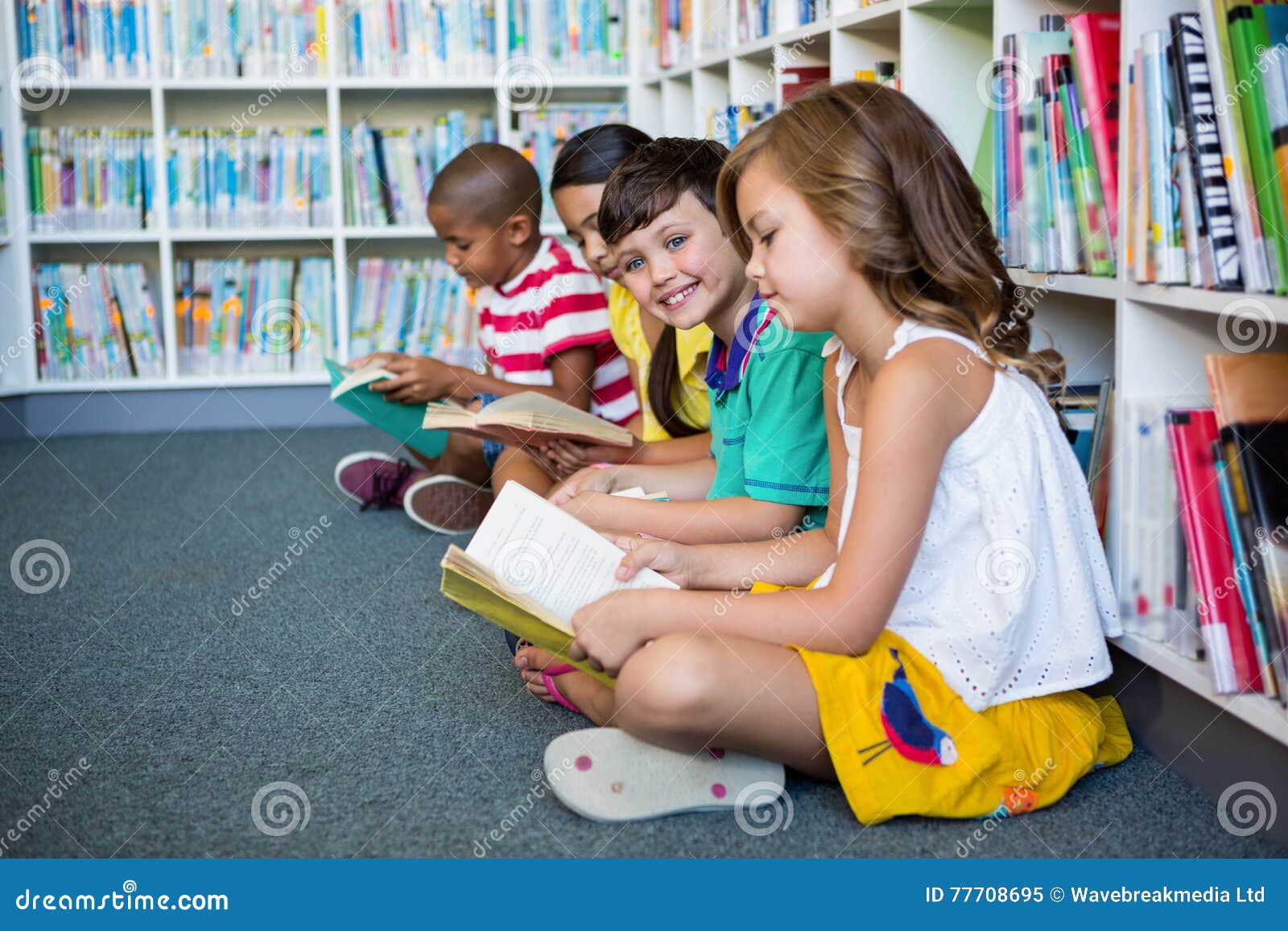 Students Reading Books while Sitting at School Library Stock Image ...