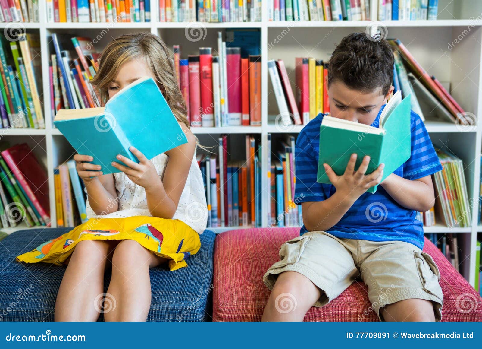 Students Reading Books while Sitting in School Library Stock Image ...