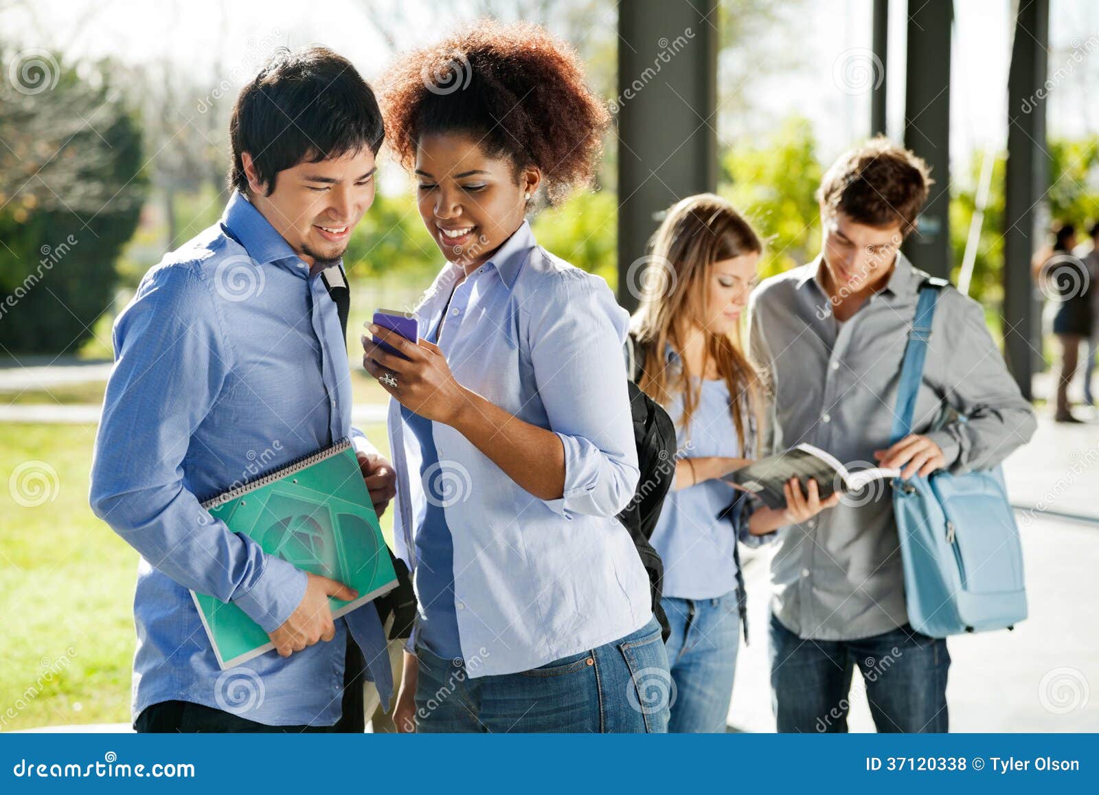 Students Reading Text Message on Mobilephone in Stock Photo - Image of ...