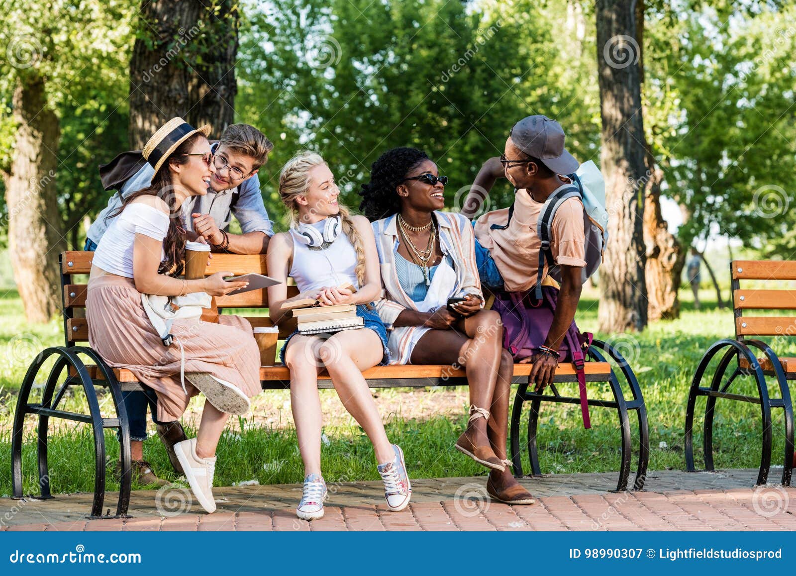Students Resting on Bench Together in Park Stock Image - Image of ...
