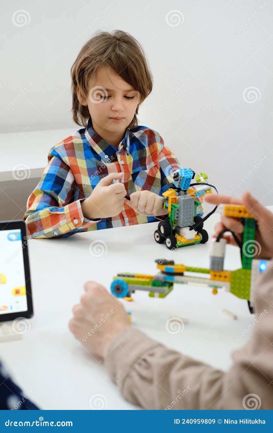 Multi Ethnic Children at Technology Lesson Coding Robot on Tablet Stock ...