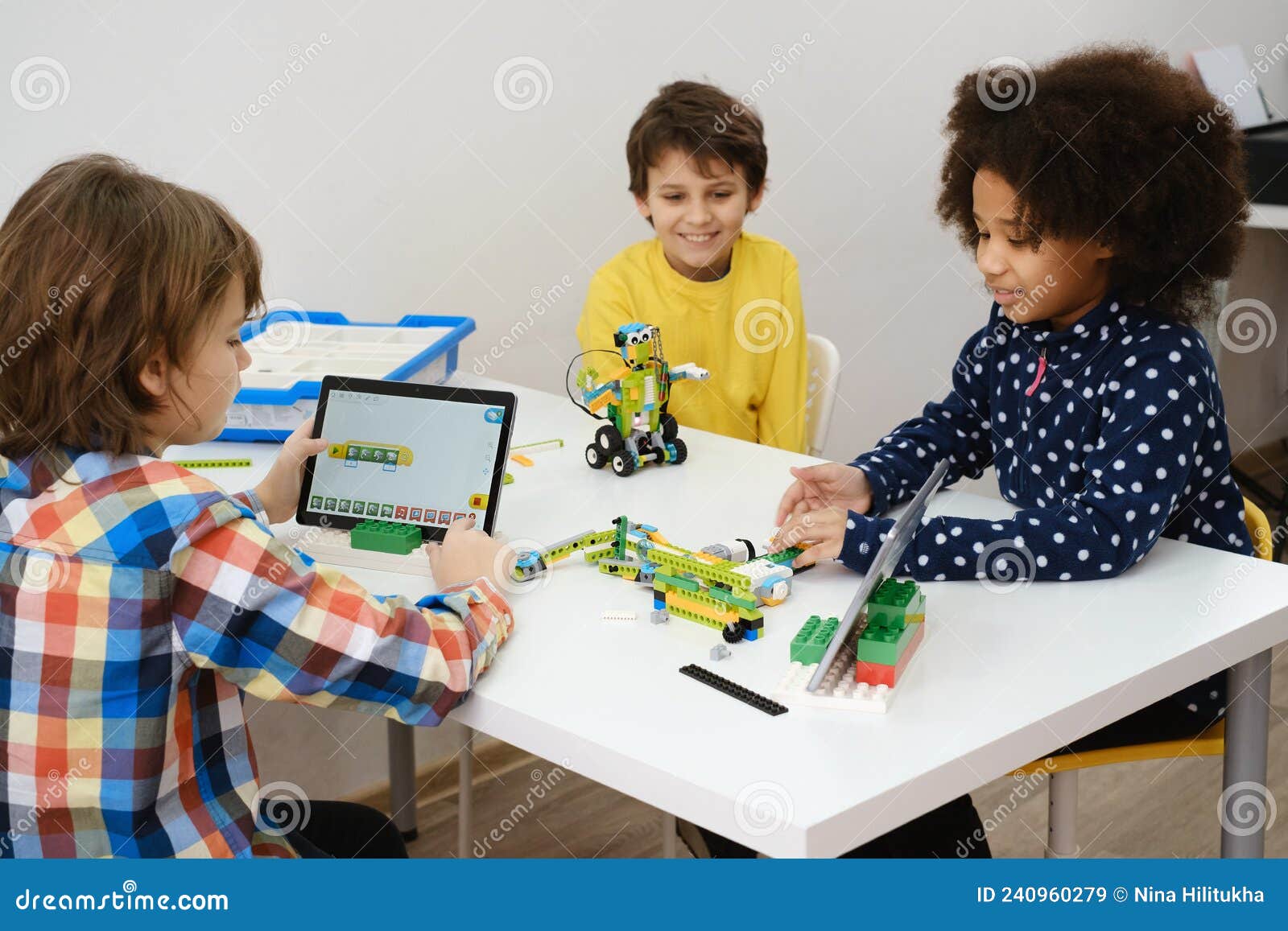 Multi Ethnic Children at Technology Lesson Coding Robot on Tablet Stock ...