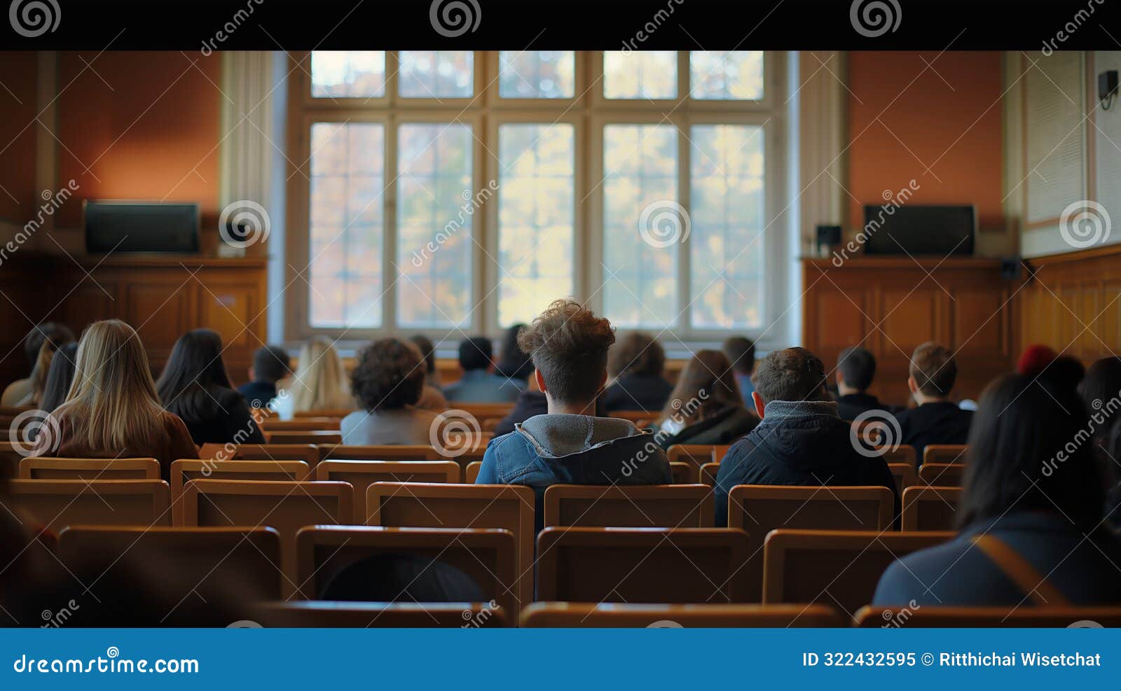 Students Seated In A Classroom, Attentively Facing The Front, With ...