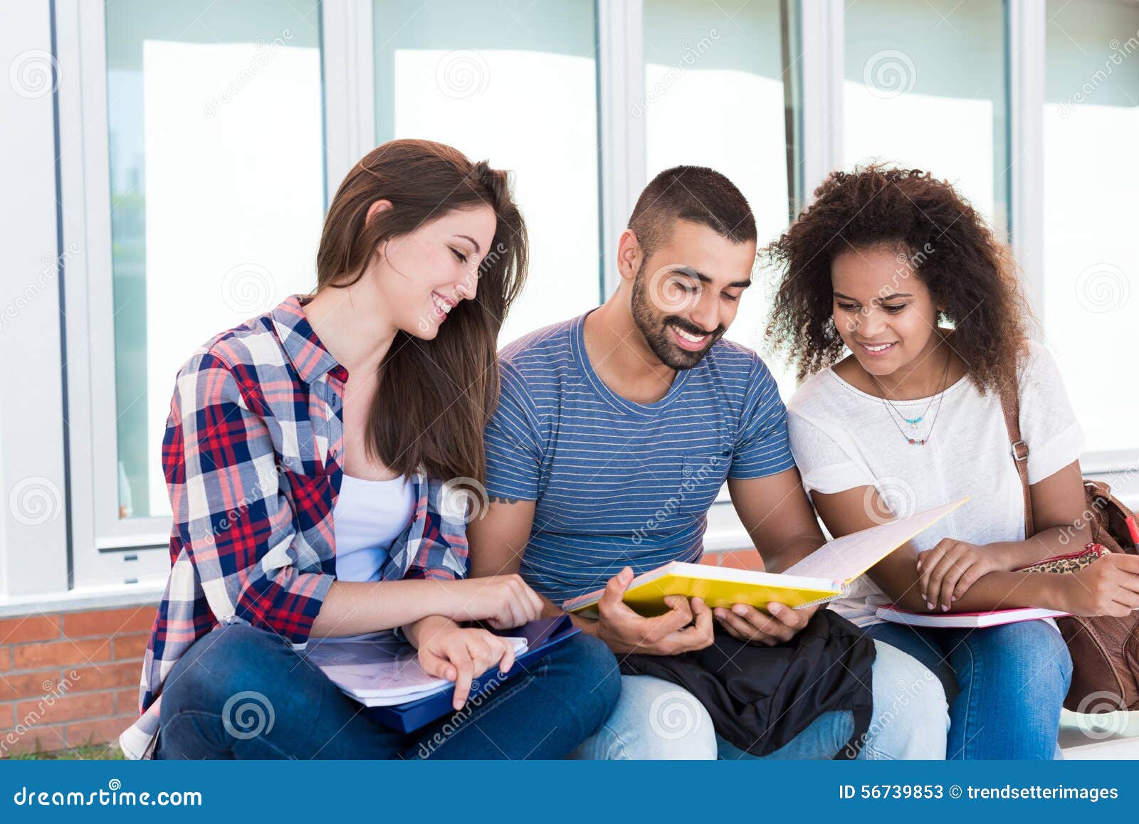 Students sharing notes stock image. Image of graduation - 56739853