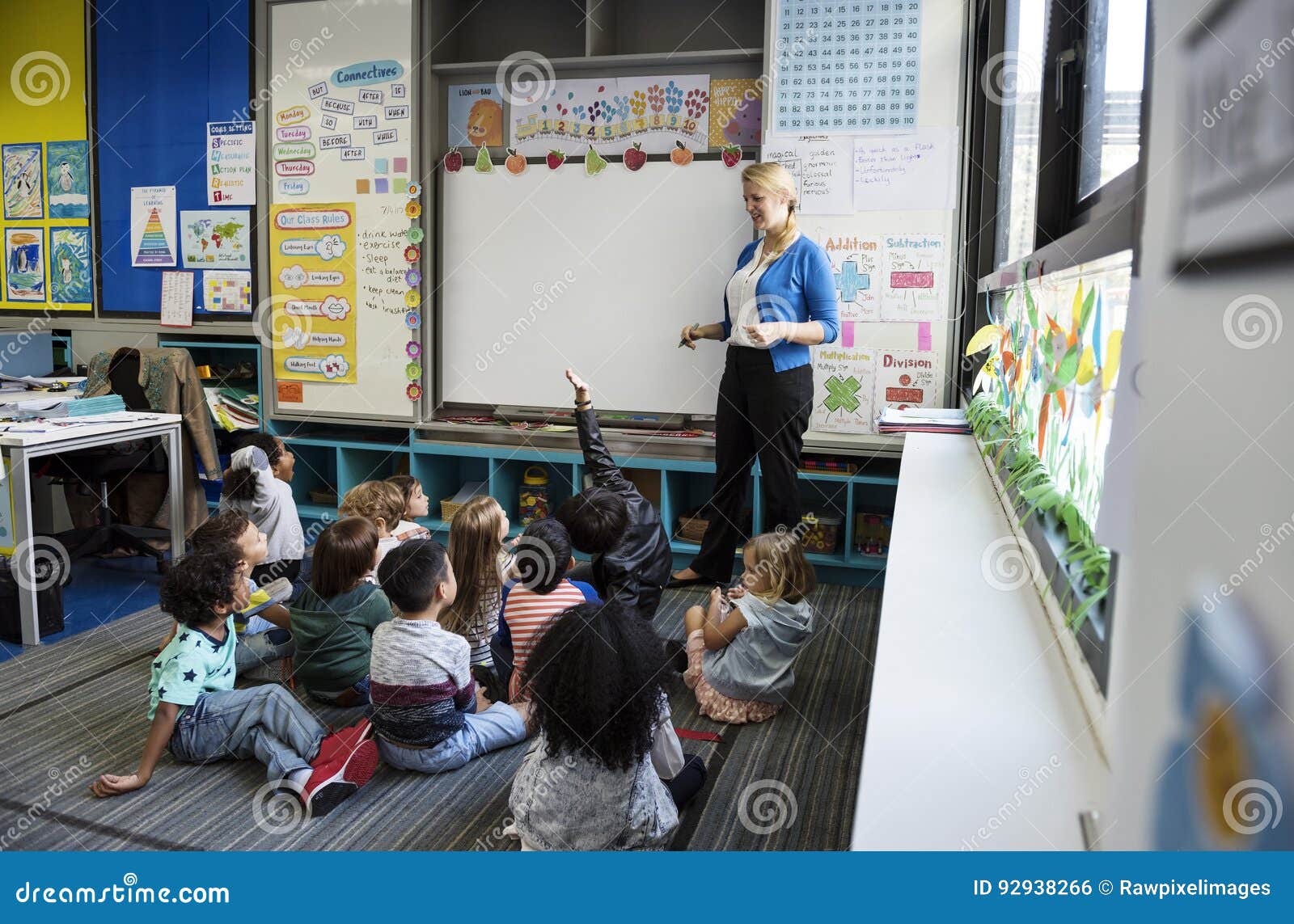 Students Sitting on the Floor Listening To Teacher Stock Photo - Image ...