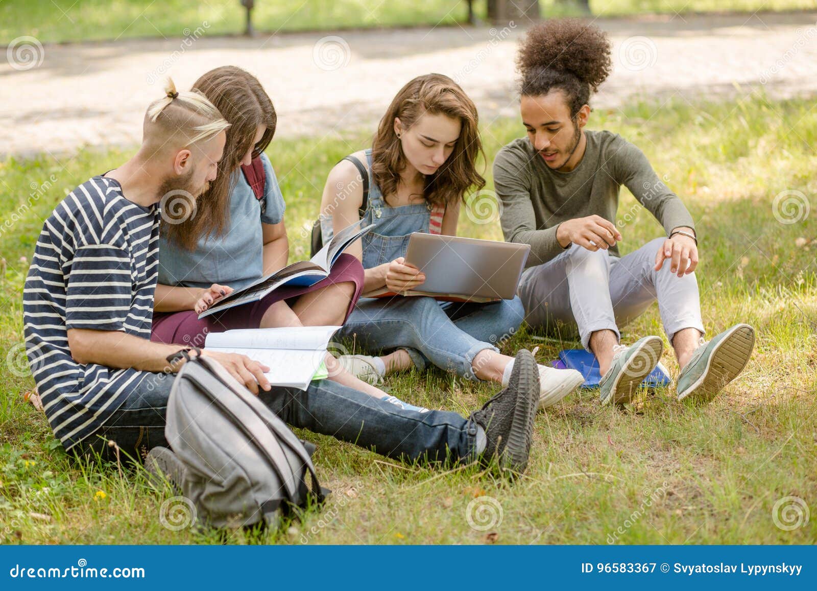 Students Sitting on Lawn Studying and Discussing Cases. Stock Image ...