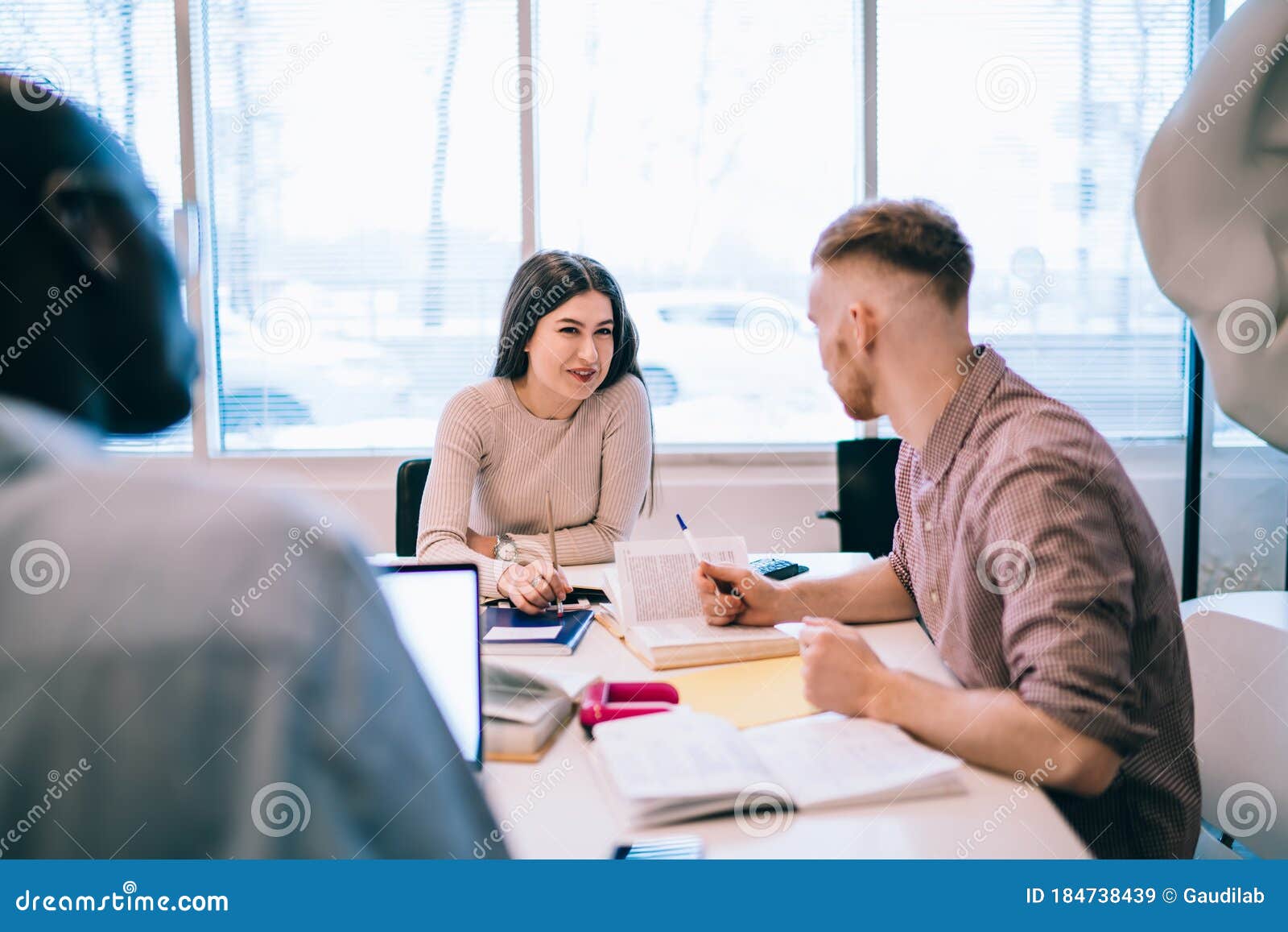 Students Sitting at Table and Chatting and Taking Notes Stock Image ...