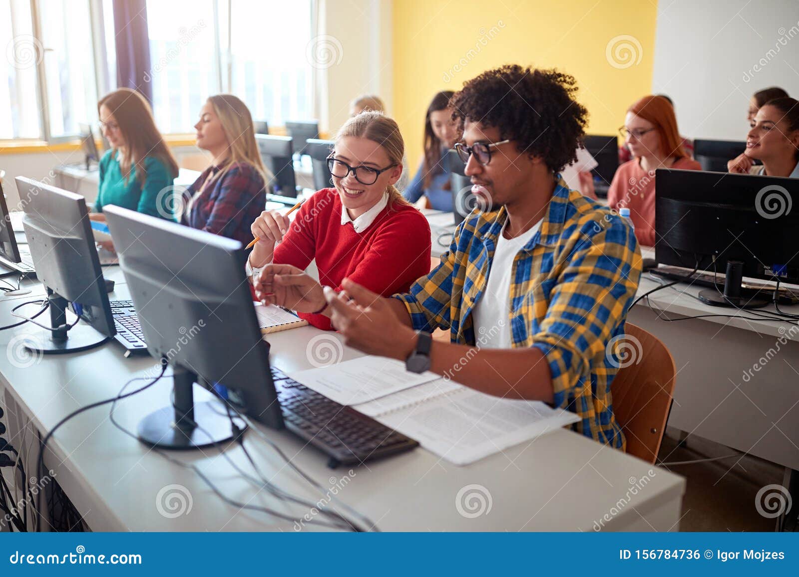 Students Sitting Together at Table Using Computer in Class on ...