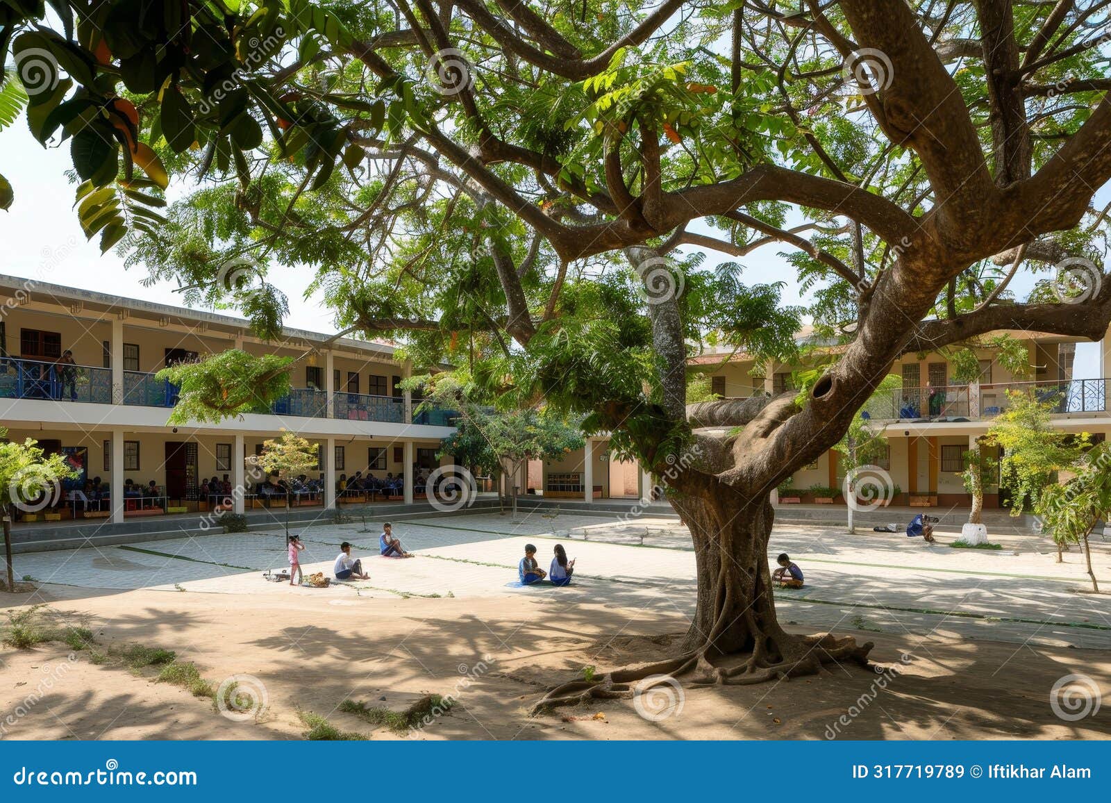 Students Sitting Under a Tree in Front of a School Building, a School ...