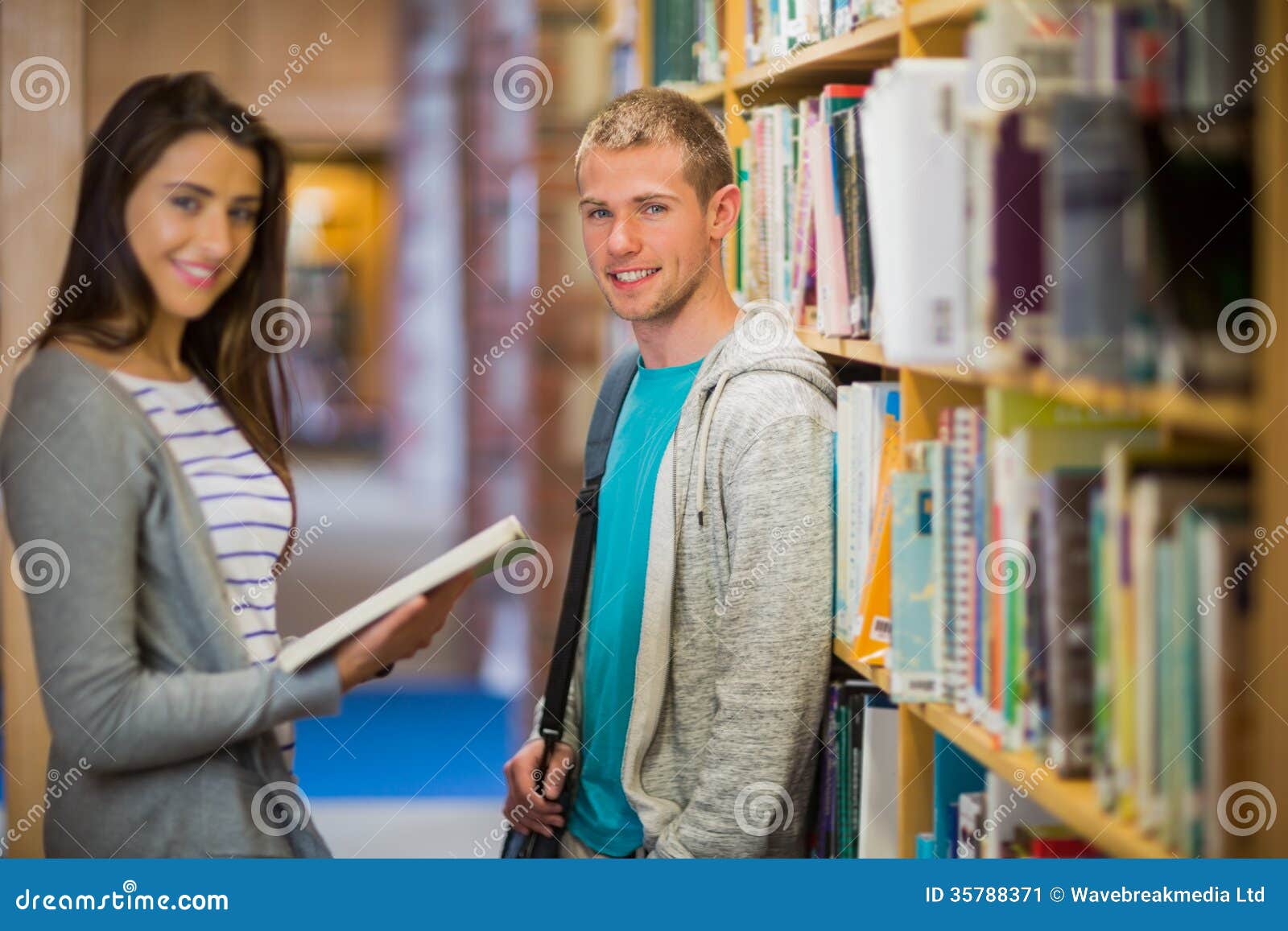 Students Standing by Bookshelf in the Library Stock Image - Image of ...