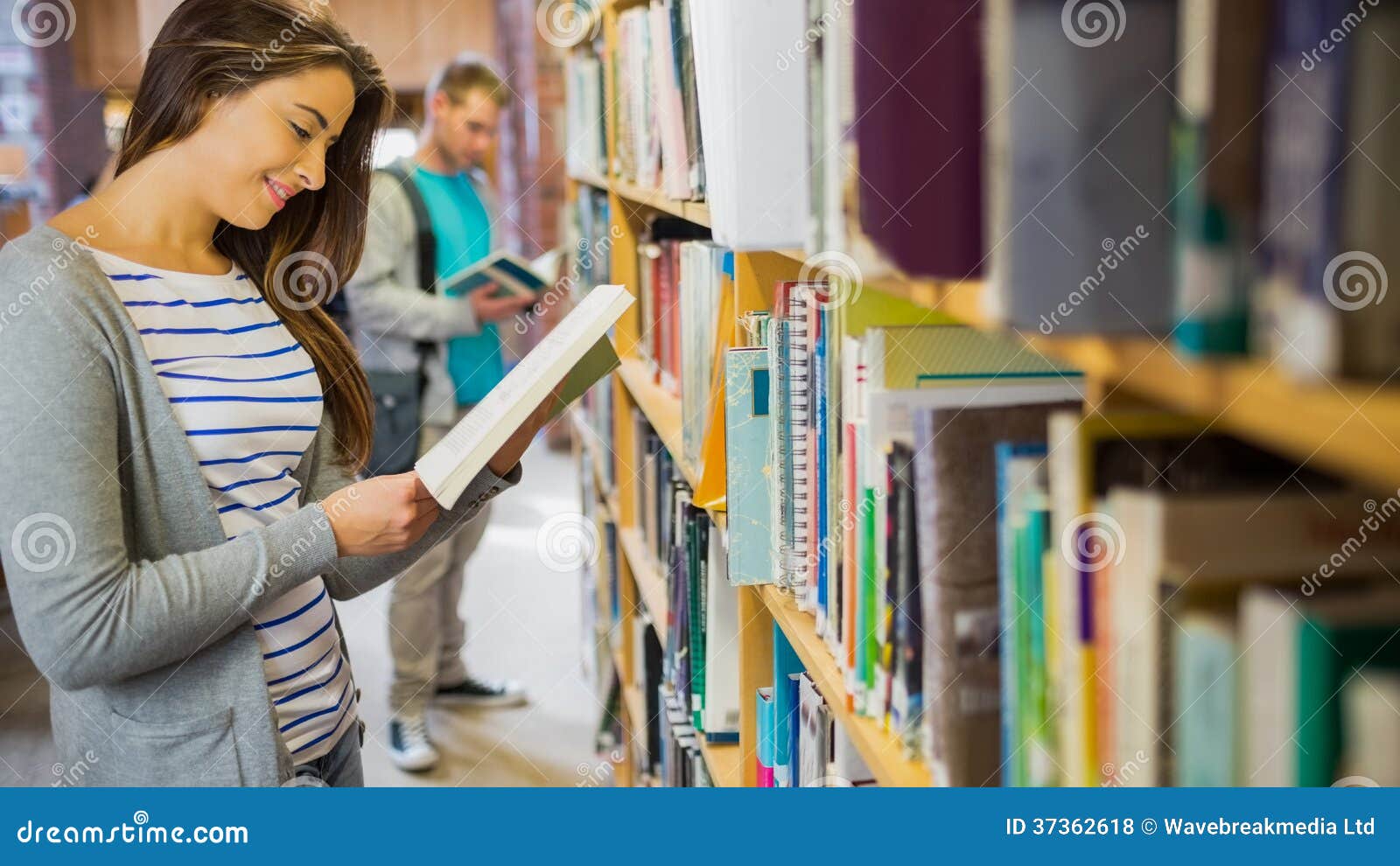 Students Standing by Bookshelf in the Library Stock Photo - Image of ...