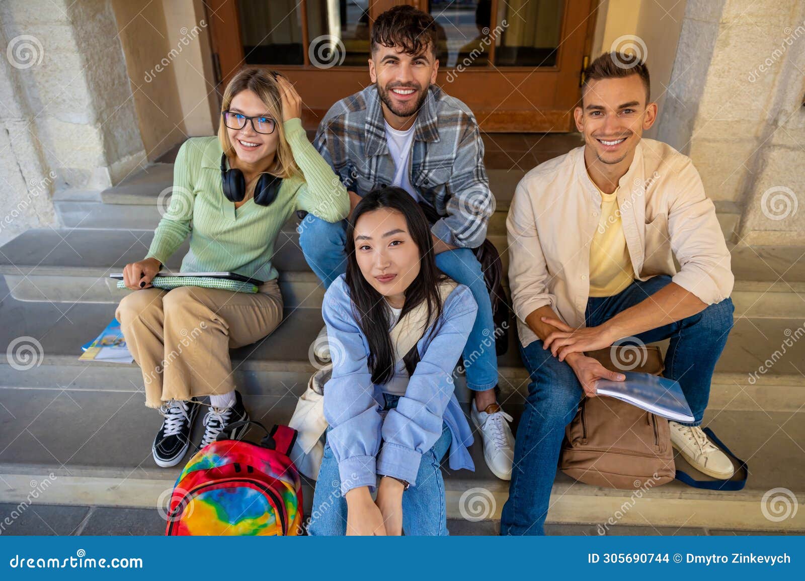 Students Studying Together Reading Book Sitting on Stairs in Campus ...