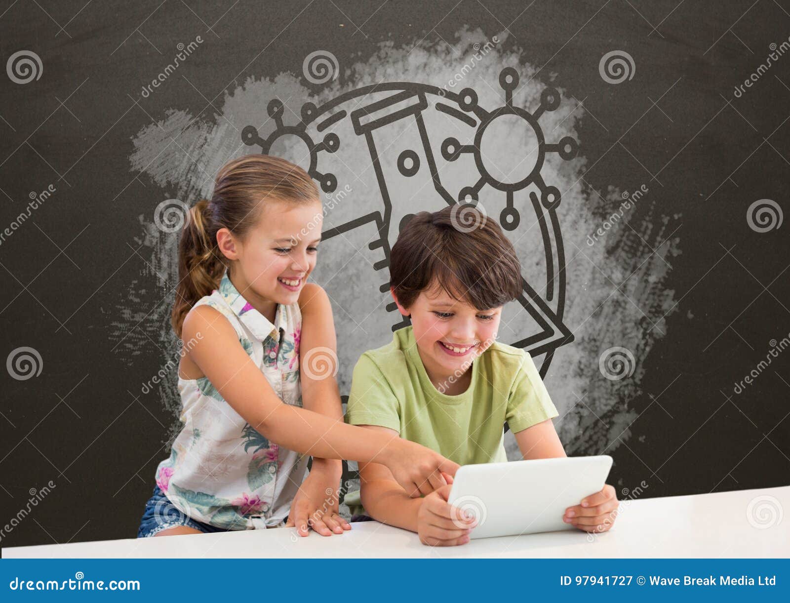 Students at Table Using a Tablet Against Grey Blackboard with School ...
