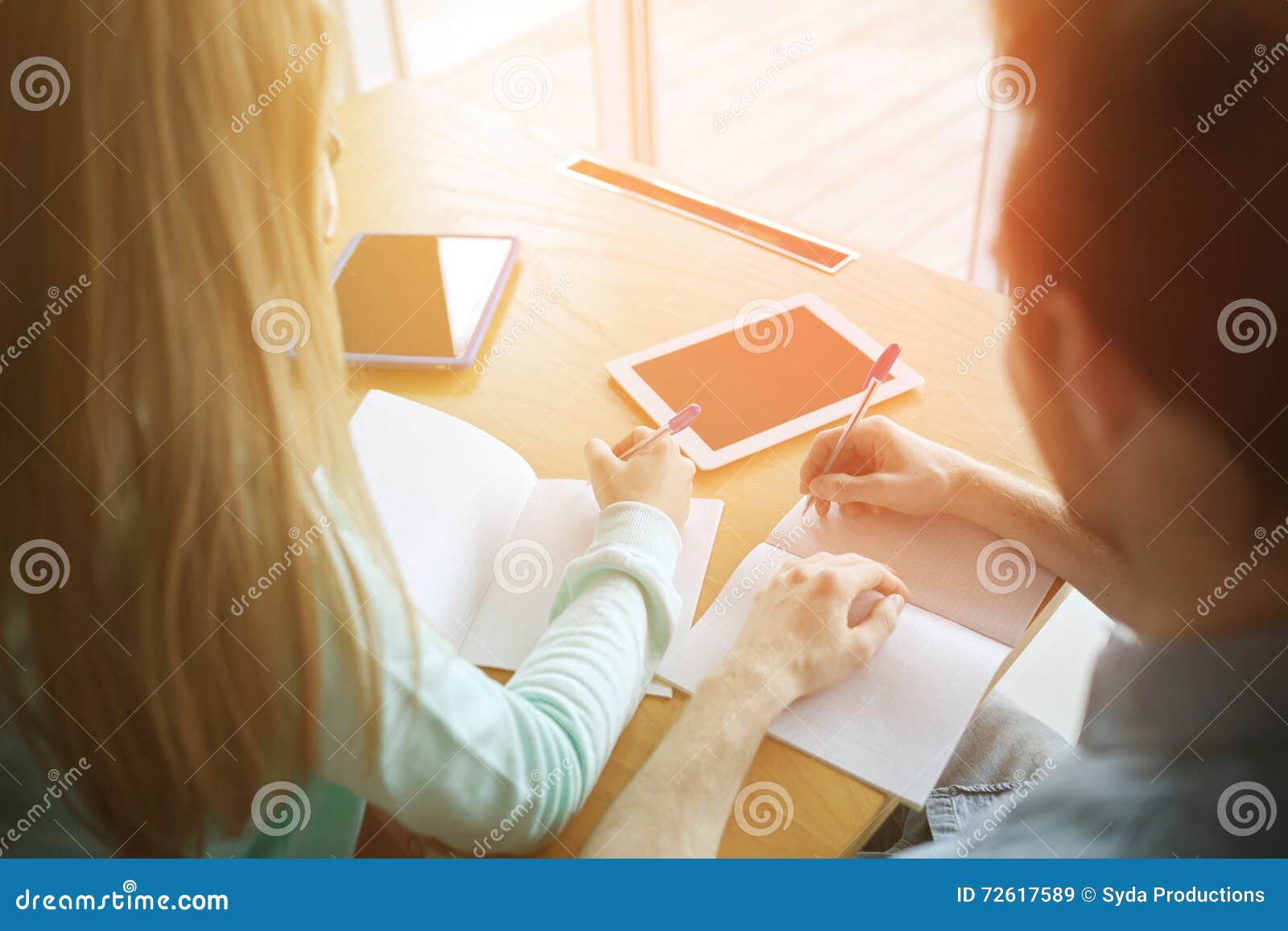 Students with Tablet Pc Writing To Notebooks Stock Image - Image of ...