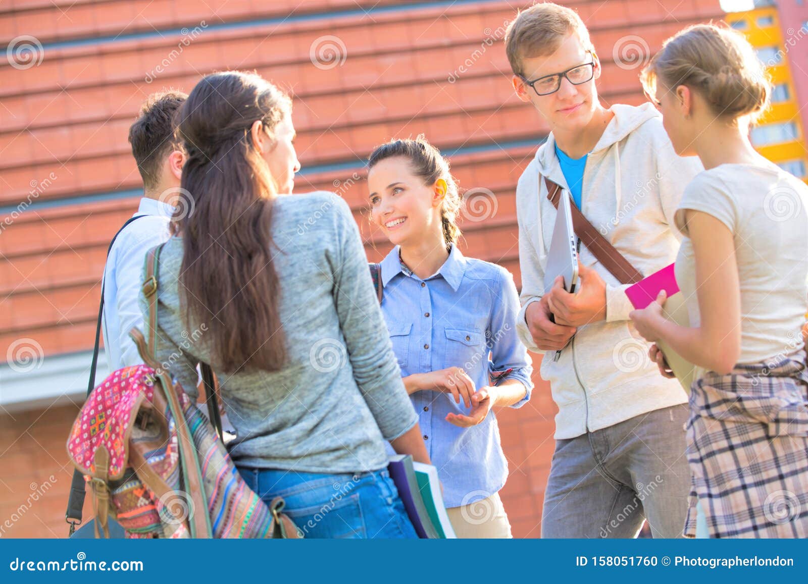 Students Talking while Standing in University Campus Stock Photo ...