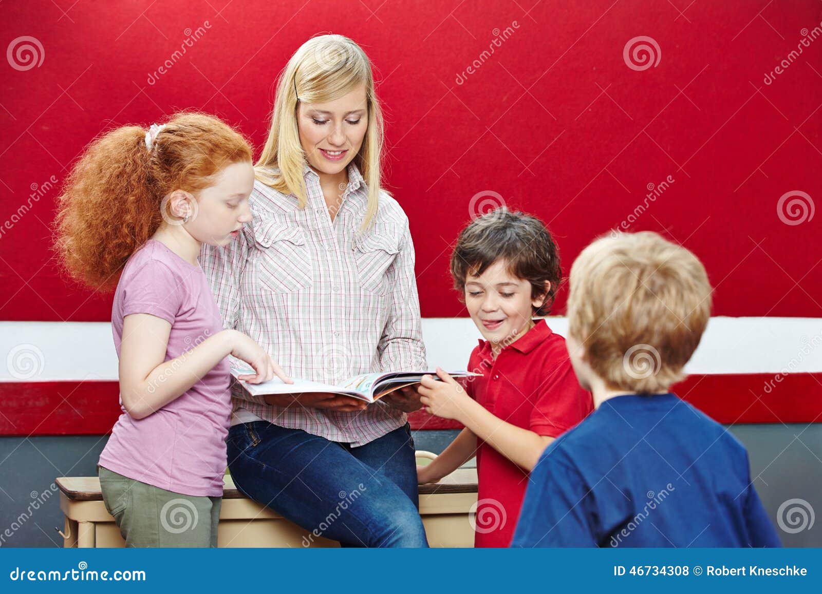 Students and Teacher Reading Book Stock Photo - Image of classroom ...