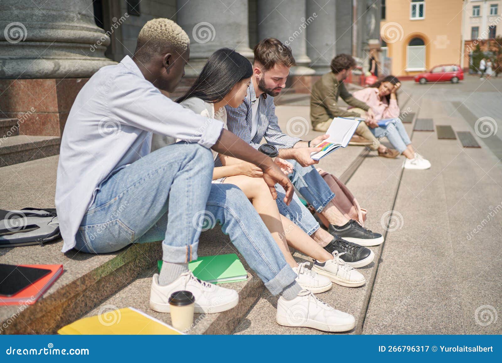 Students with Textbooks Sitting on the Steps. Stock Image - Image of ...