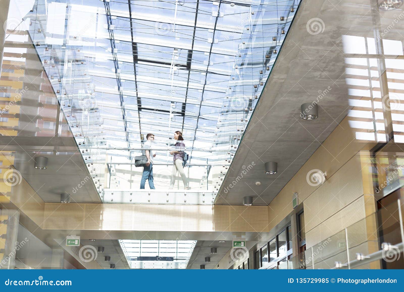 Low Angle View of Students Walking on Glass Floor at University Campus ...