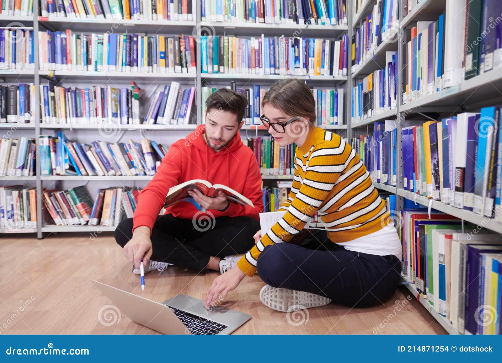 The Students Uses a Notebook, Laptop and a School Library Stock Photo ...