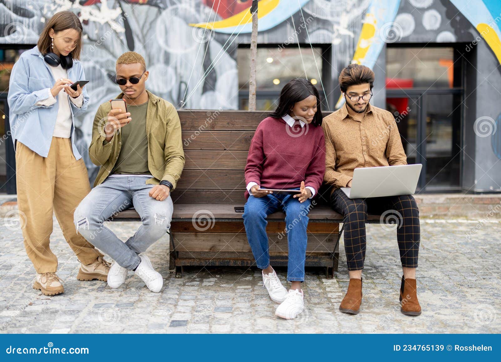 Students Using Digital Devices on Wooden Bench Stock Image - Image of ...