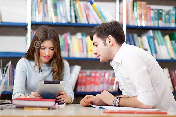 Students Using a Digital Tablet in a Library Stock Image - Image of ...