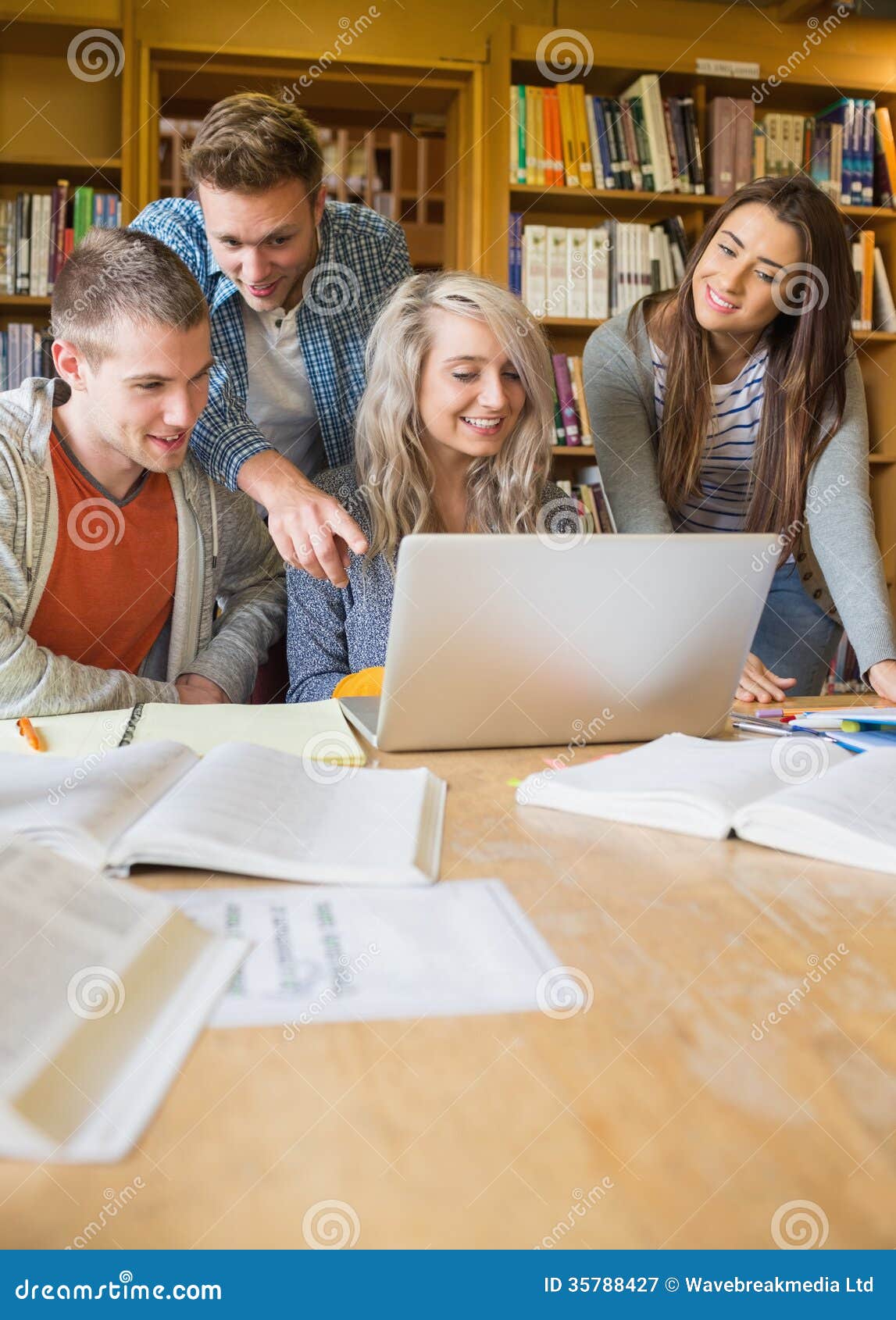 Students Using Laptop at Desk in Library Stock Image - Image of ...