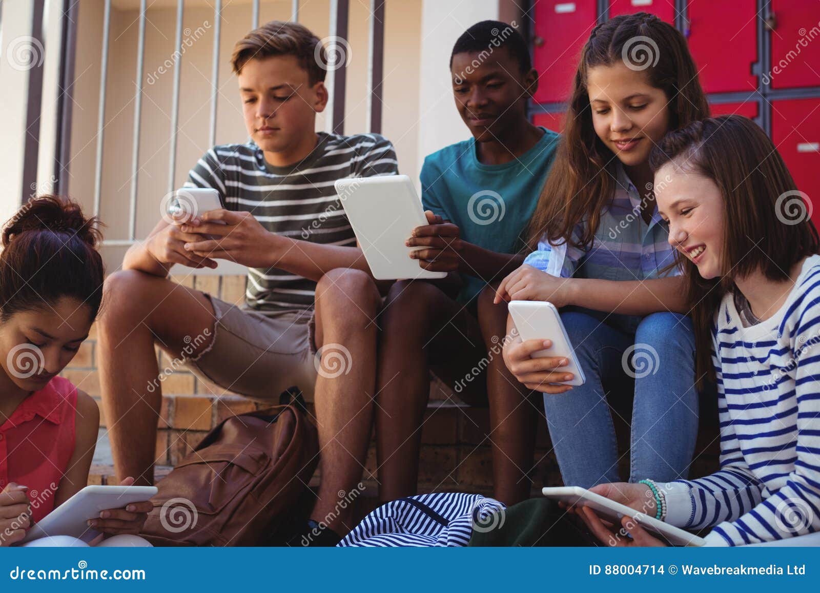 Students Using Mobile Phone and Digital Tablet on Staircase Stock Photo ...