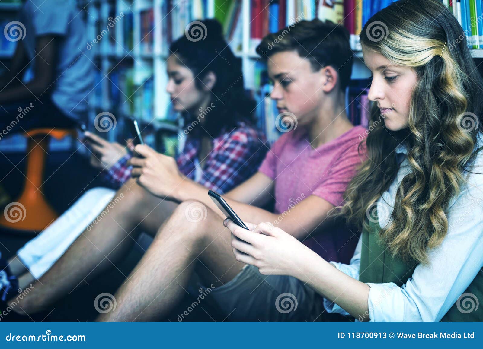 Students Using Mobile Phone in Library Stock Image - Image of holding ...