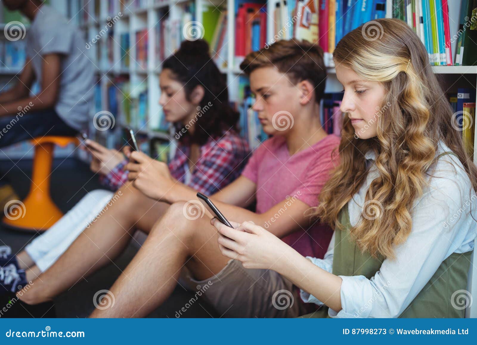 Students Using Mobile Phone in Library Stock Image - Image of female ...
