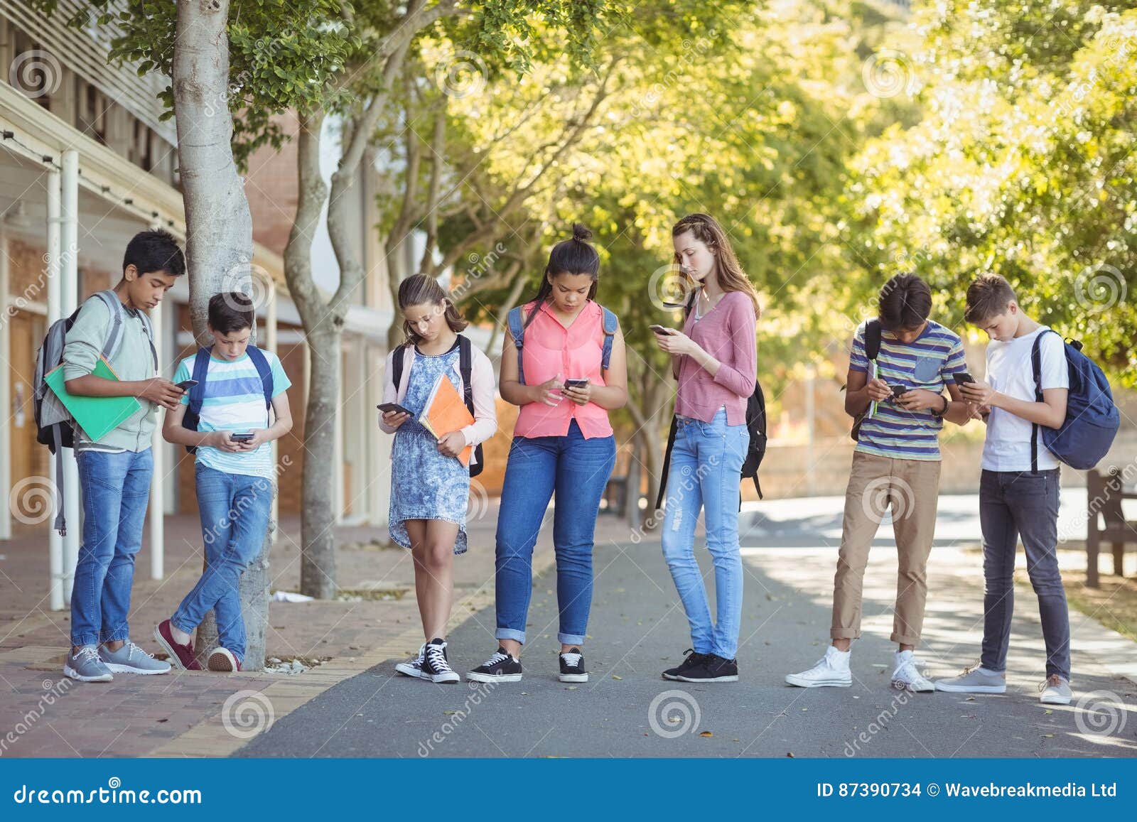 Students Using Mobile Phone on Road in Campus Stock Photo - Image of ...
