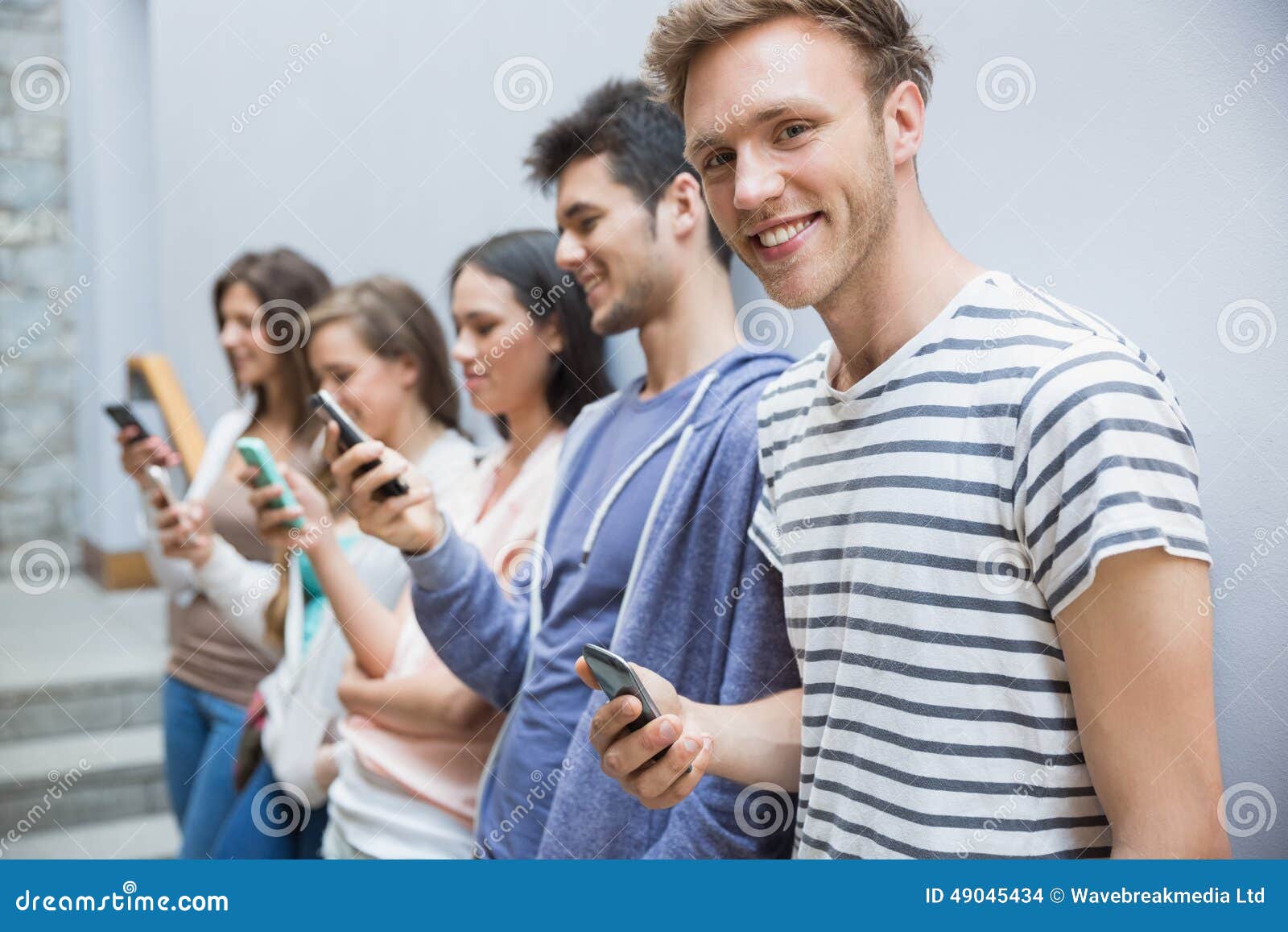 Students Using Their Smartphones in a Row Stock Photo - Image of five ...