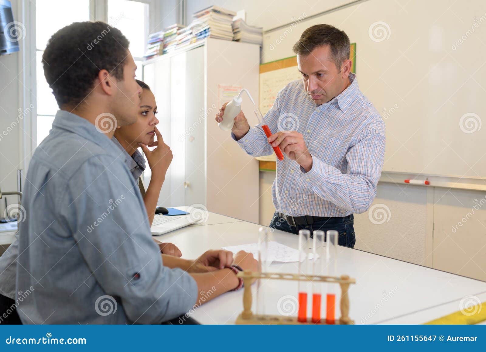 Students Watching Teacher Drip Reagent into Test Tube Stock Image ...