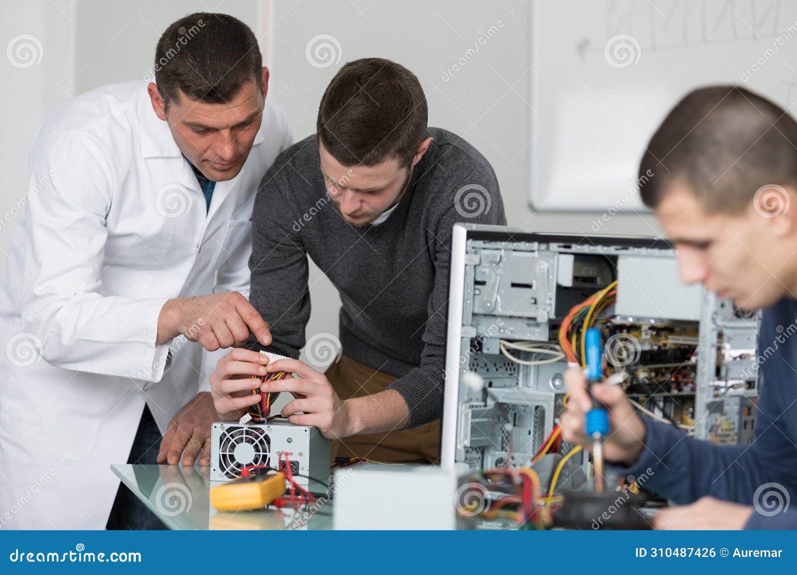 Students Working on Computer Components with Soldering Iron and ...