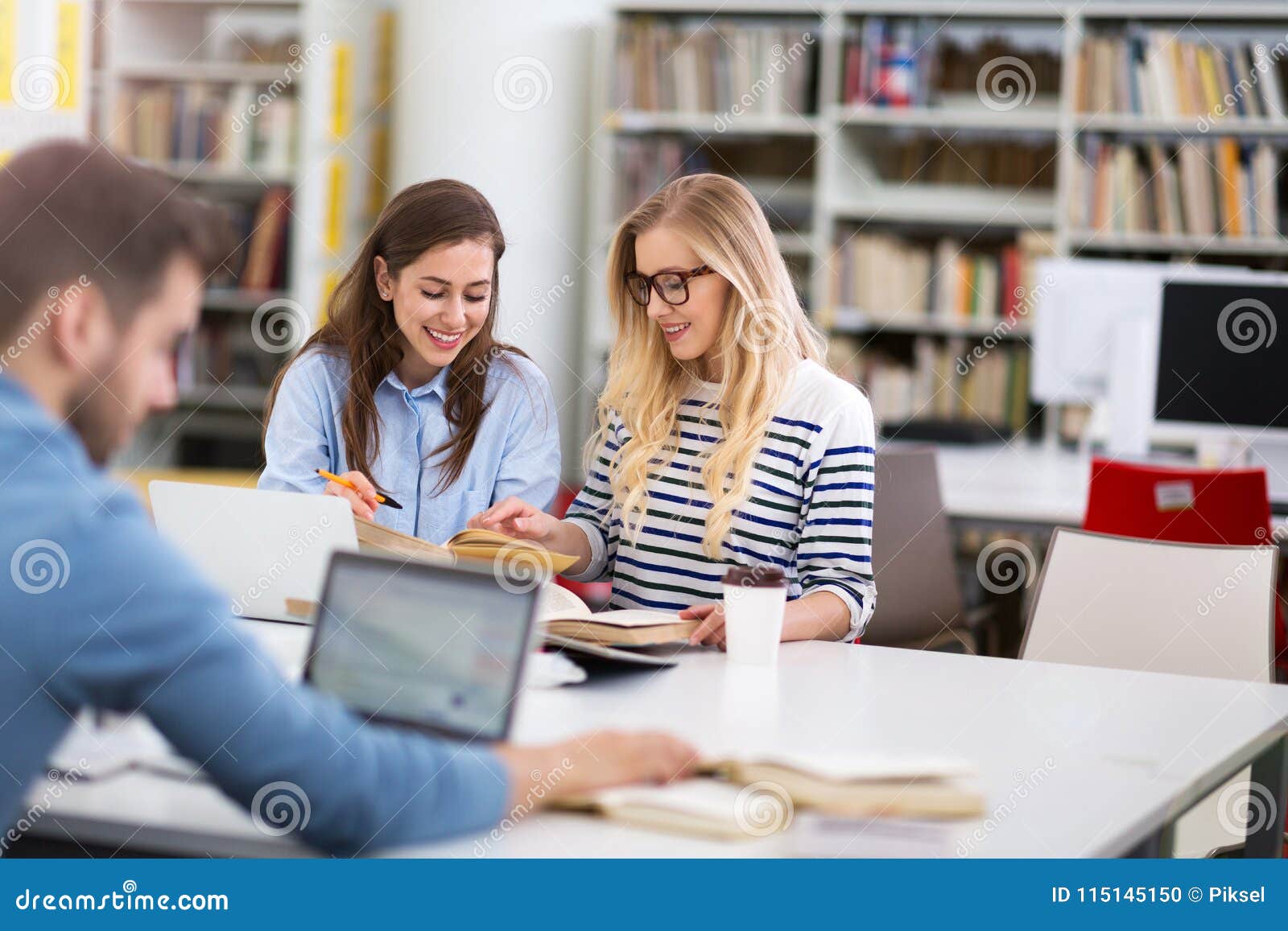 Students Working in the Library at Campus Stock Photo - Image of ...
