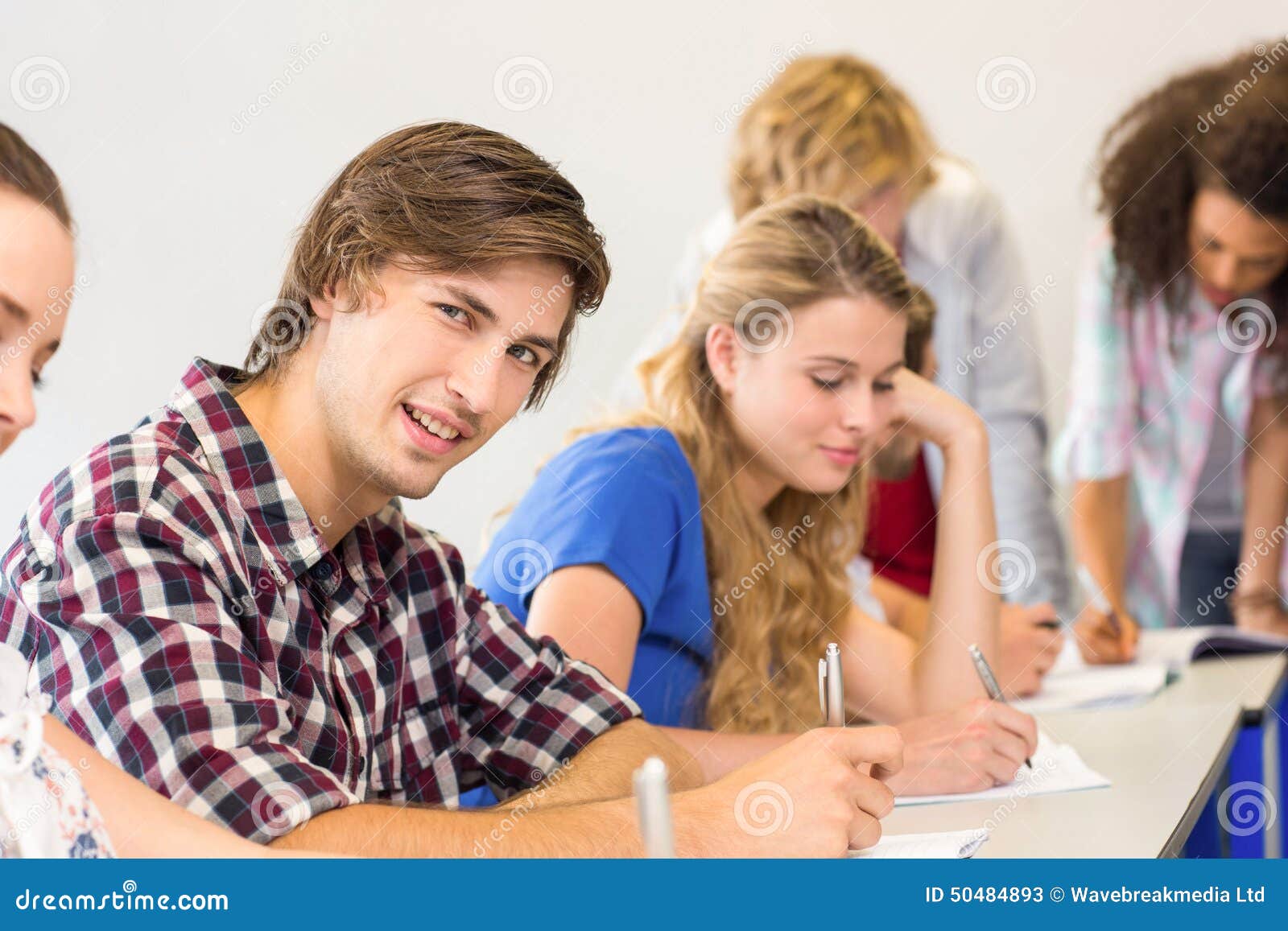 Students Writing Notes in Classroom Stock Image - Image of line, notes ...