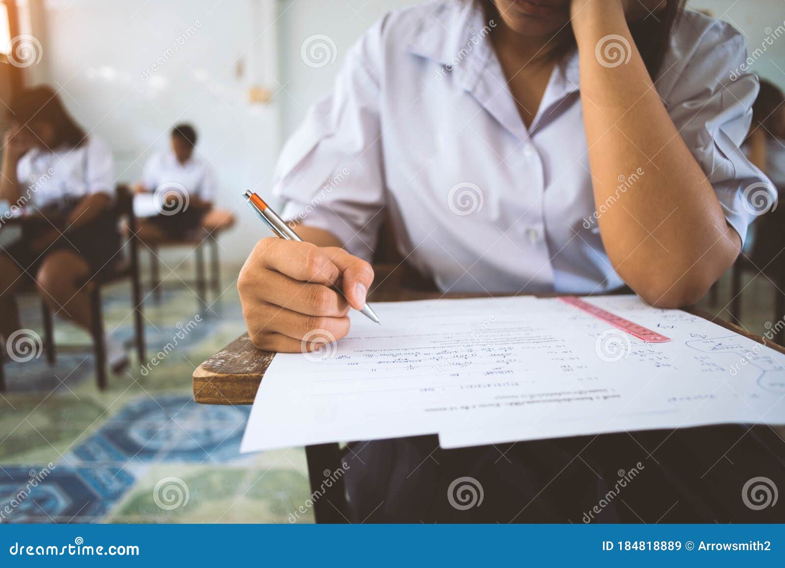 Students Writing Pen in Hand Doing Exams Answer Sheets Exercises in ...