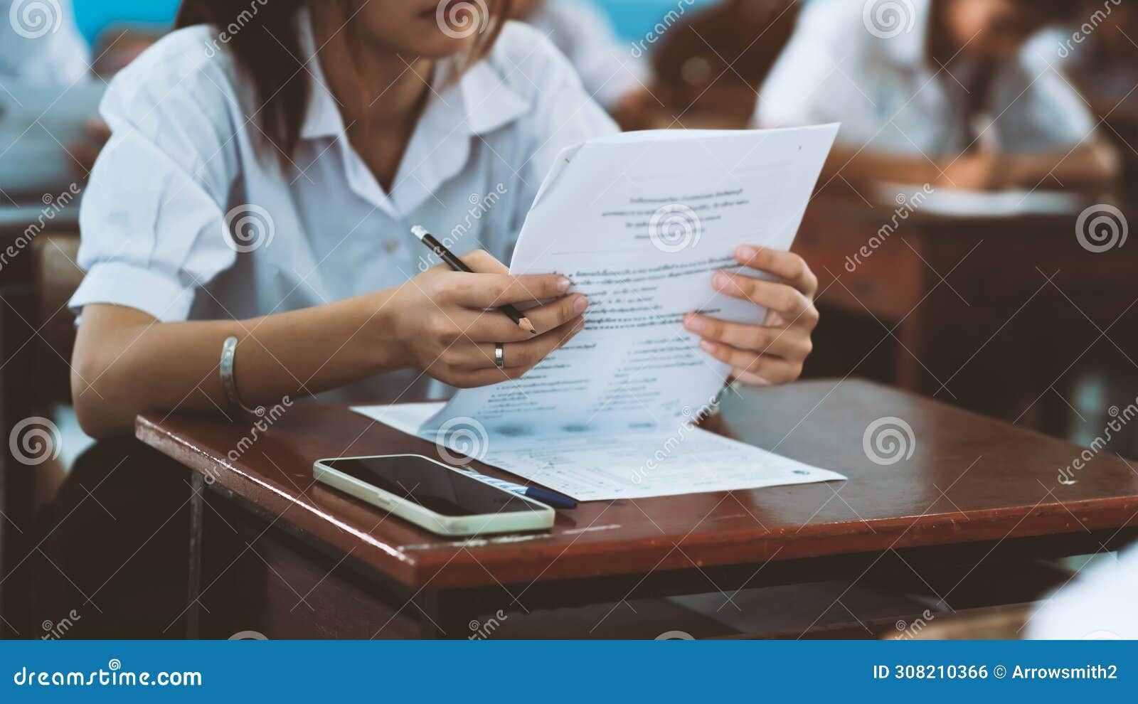 Students Writing and Reading Exam Answer Sheets Exercises in Classroom ...