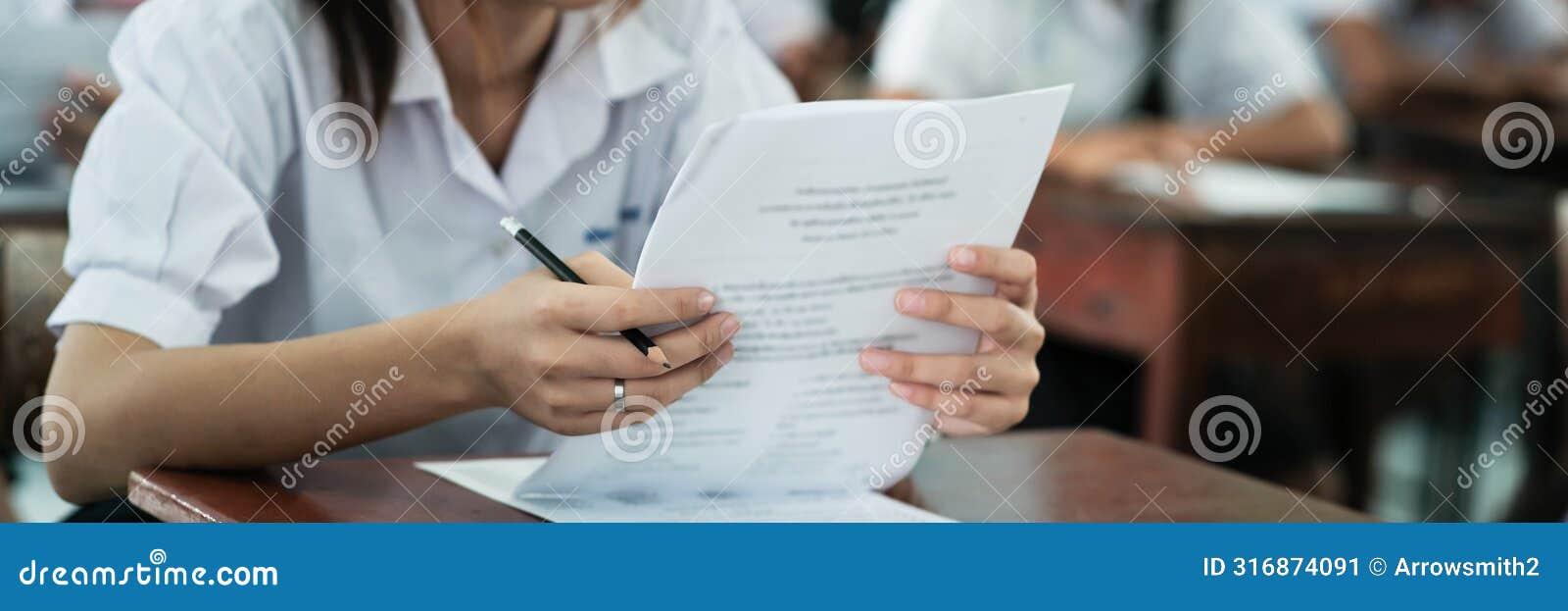 Students Writing and Reading Exam Answer Sheets Exercises in Classroom ...