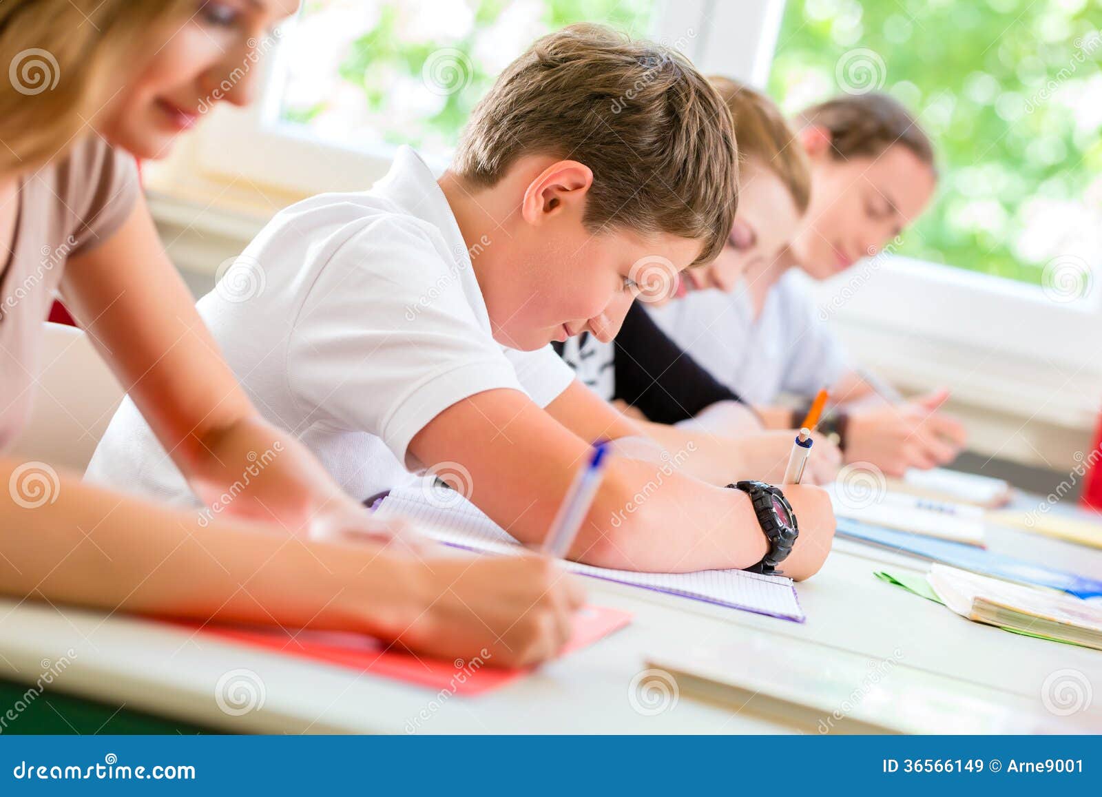 Students Writing a Test in School Concentrating Stock Image - Image of ...