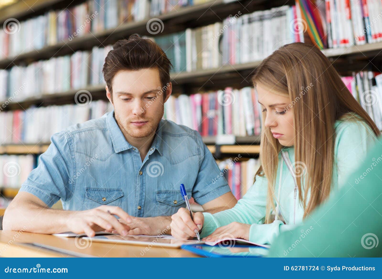 Students Writing To Notebooks in Library Stock Photo - Image of ...